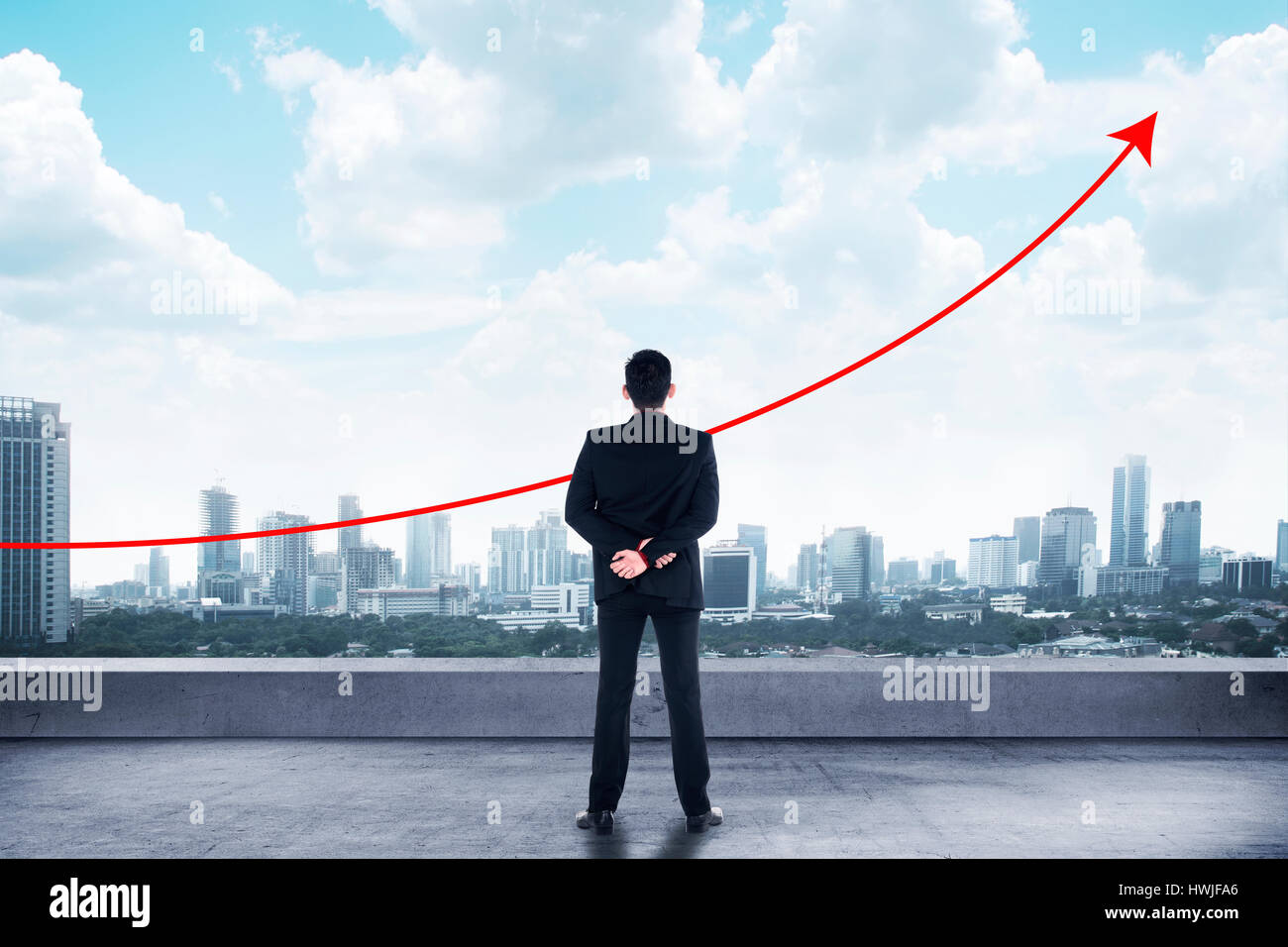 Asian man standing looking the city watching the graph raise Stock ...