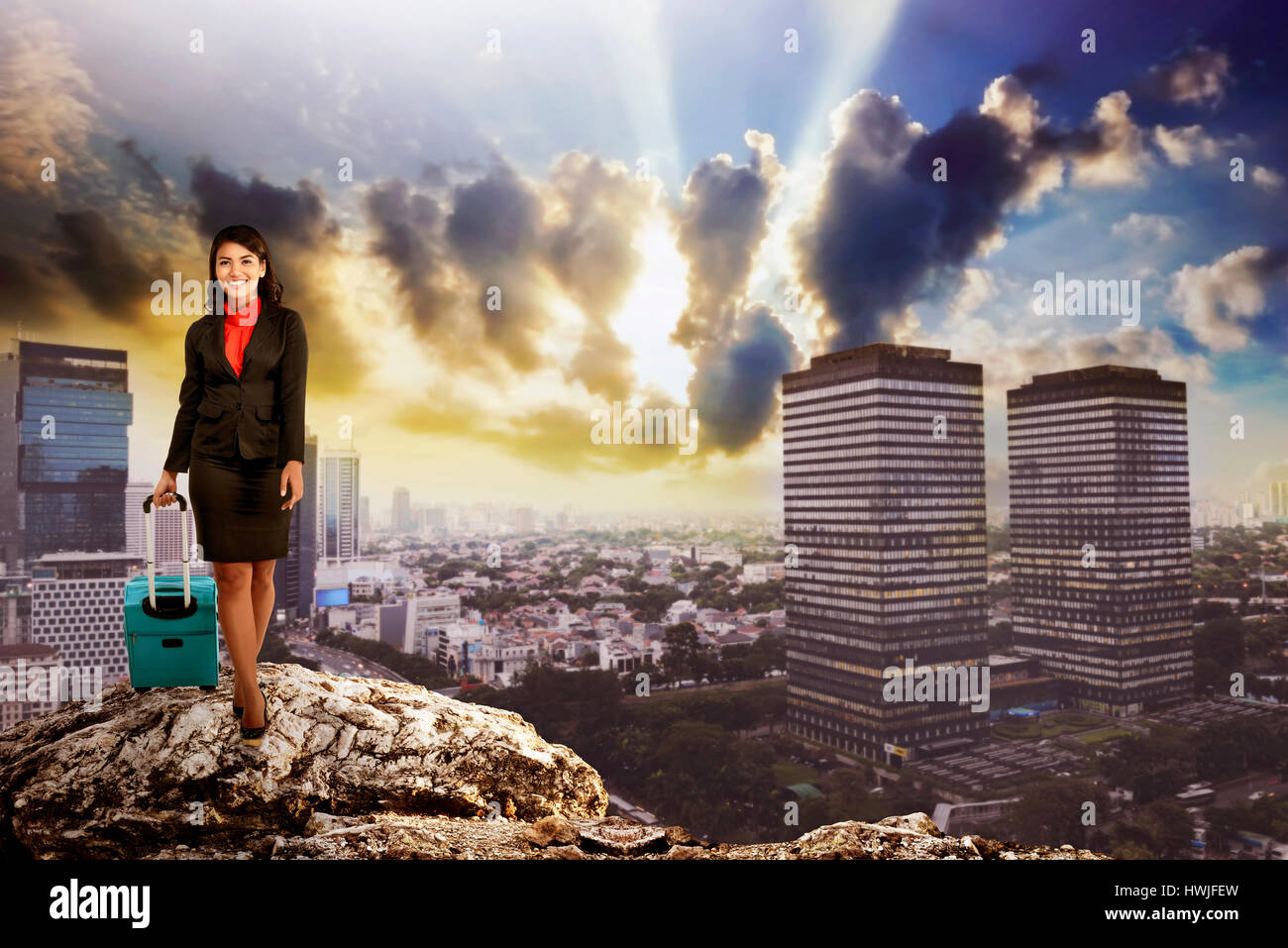 Business woman holding suitcase with city background Stock Photo - Alamy Business woman holding suitcase with city background Stock Photo - Alamy
