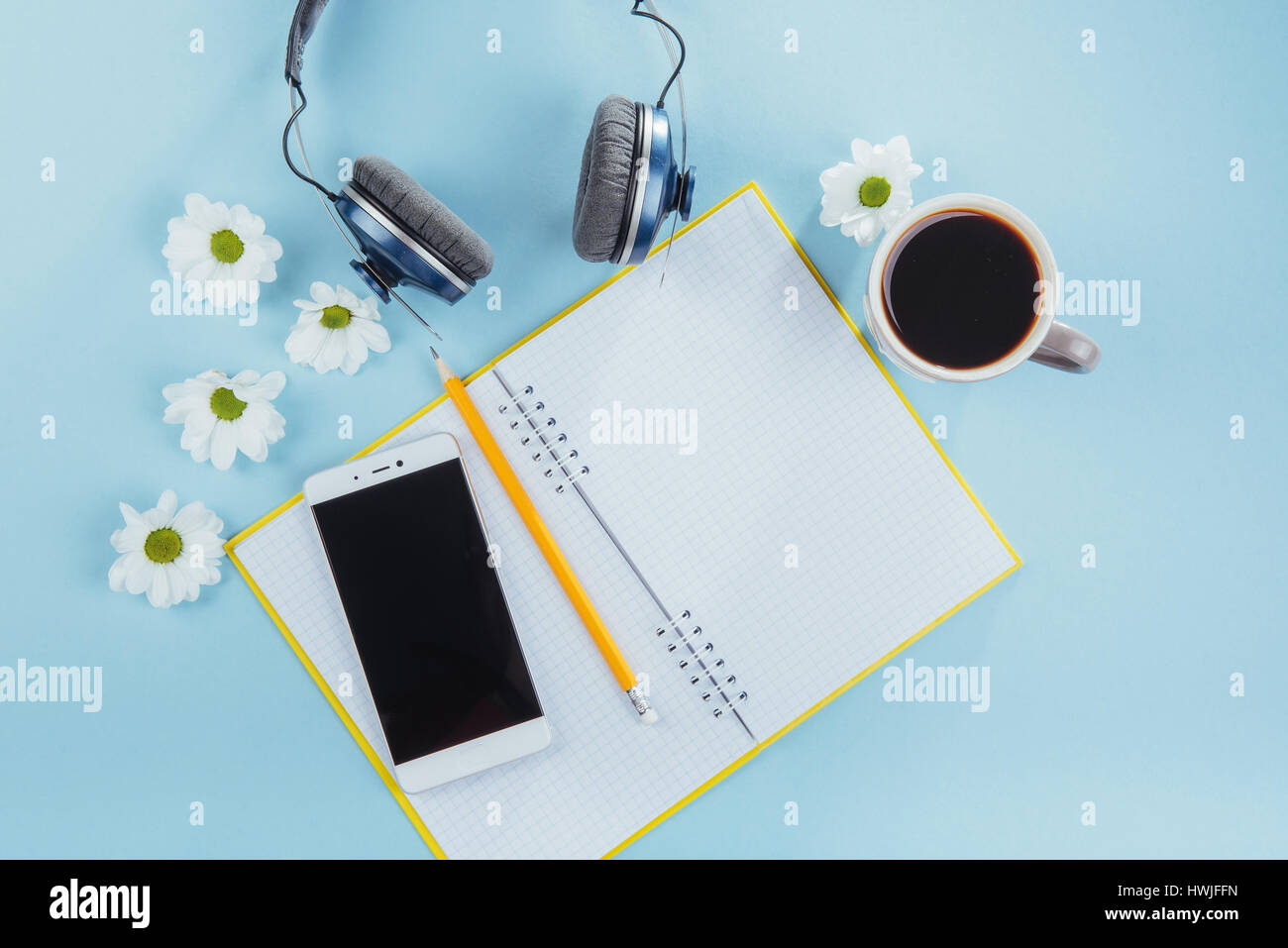 On the blue background notebook pencil, ruler and white flowers Stock ...