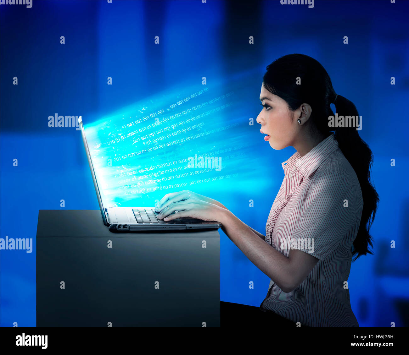 Business woman working with laptop with binary number come out from ...