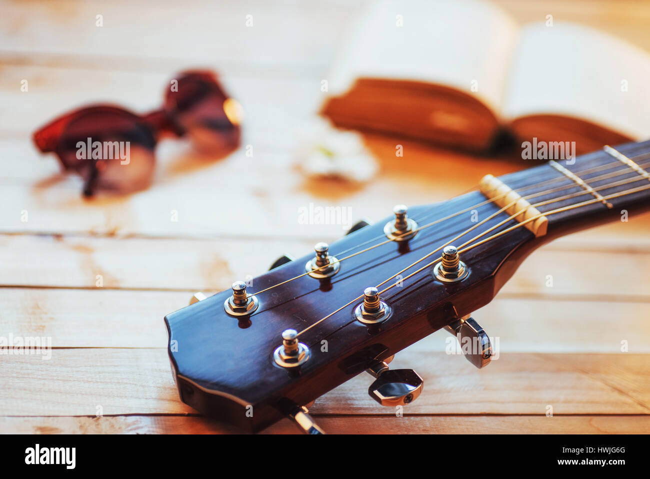 close up neck acoustic classical guitar on a light wooden background ...