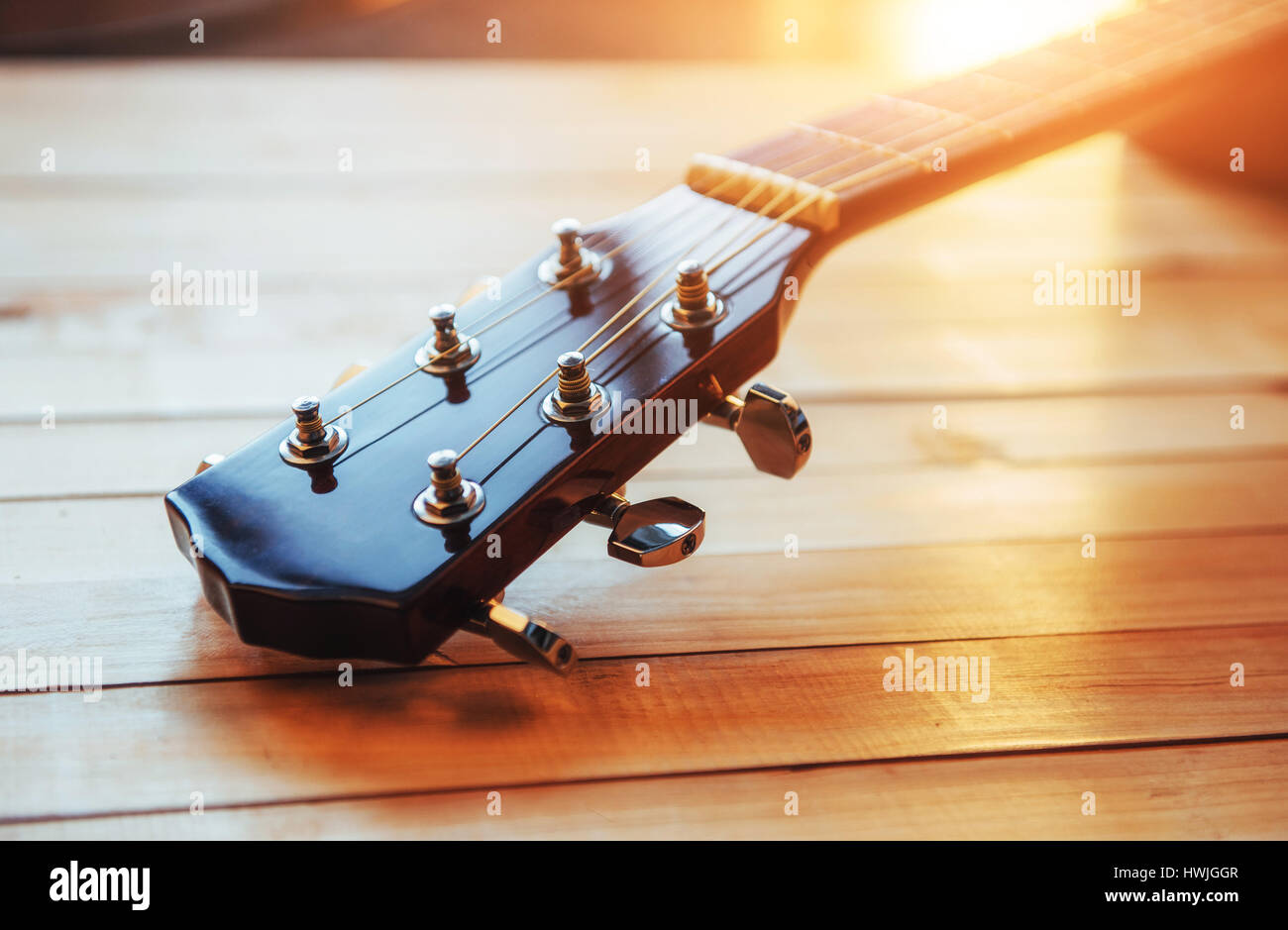 close up neck acoustic classical guitar on a light wooden background ...