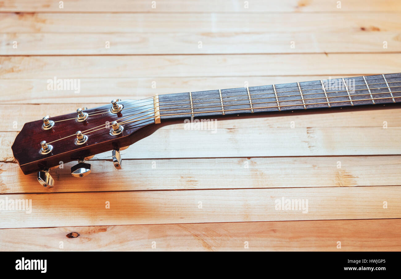 close up neck acoustic classical guitar on a light wooden background ...