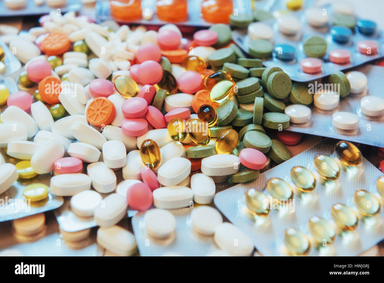 Pills of different colors lie on the surface in a sealed package Stock ...