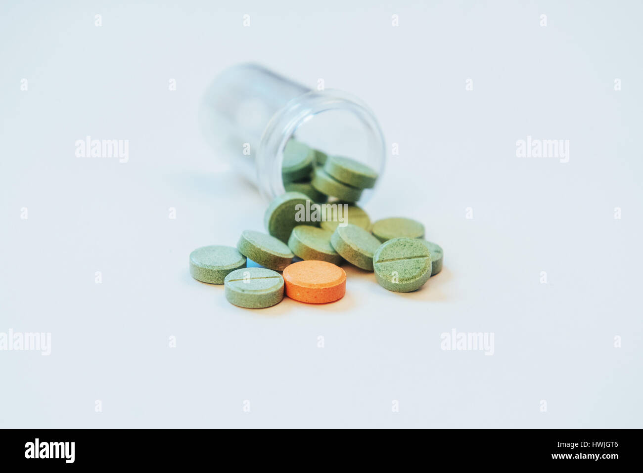 Medical green pills for treatment and health care on a white background ...