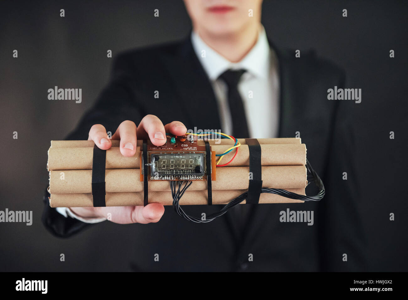 Man terrorist in a black suit with explosives and detonators Stock ...