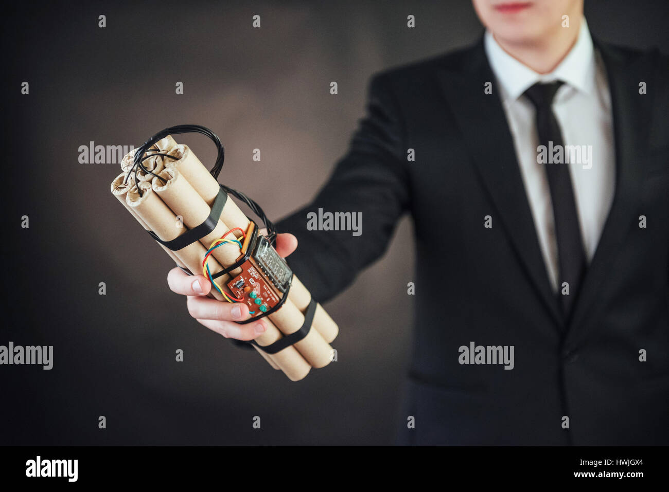 Man terrorist in a black suit with explosives and detonators Stock ...