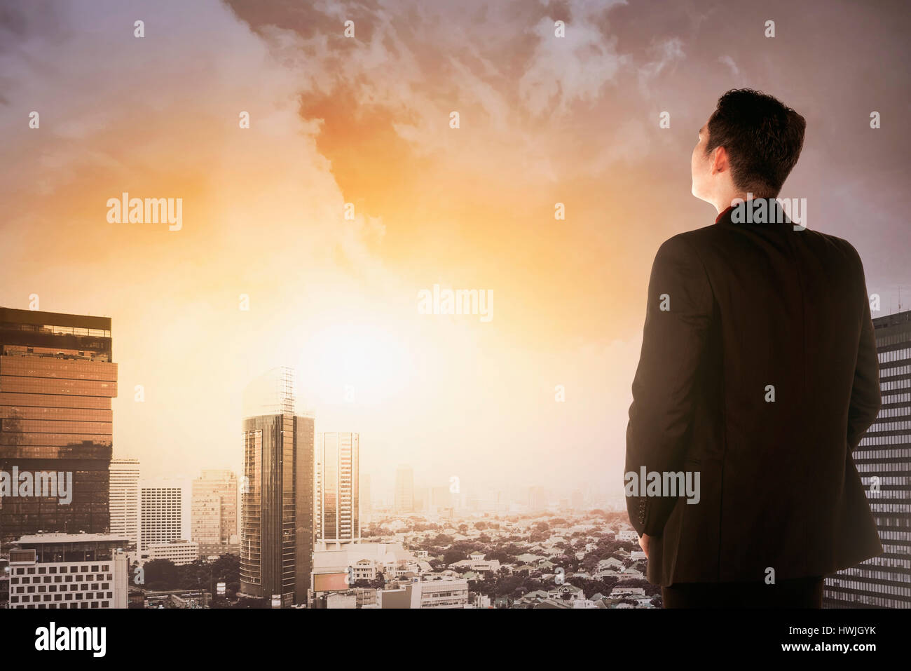 Back view of asian business man looking the city from the rooftop Stock ...