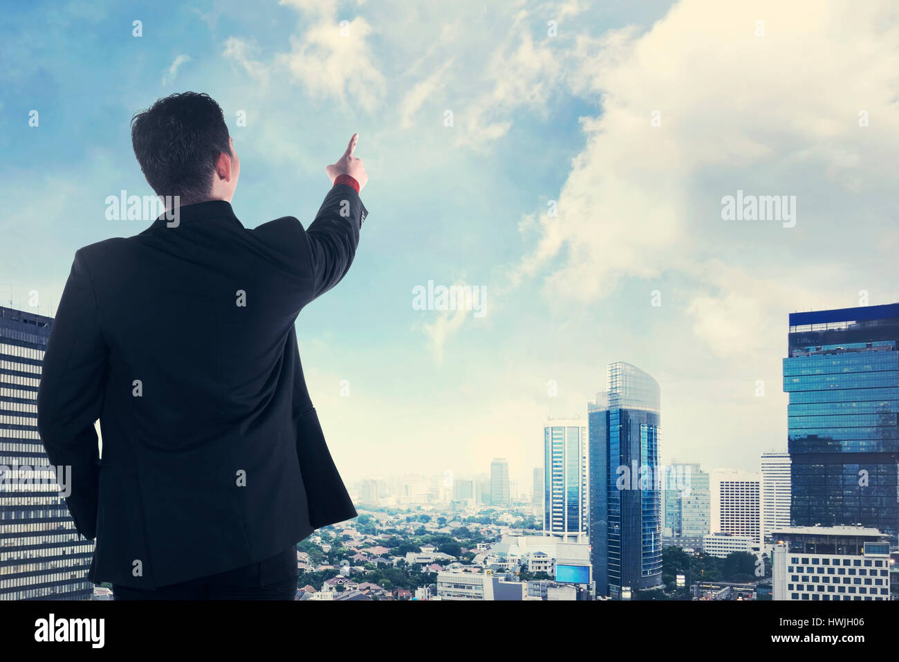 Back view of asian business man looking the city from the rooftop Stock ...