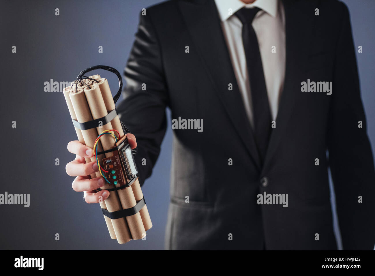 Man terrorist in a black suit with explosives and detonators Stock ...