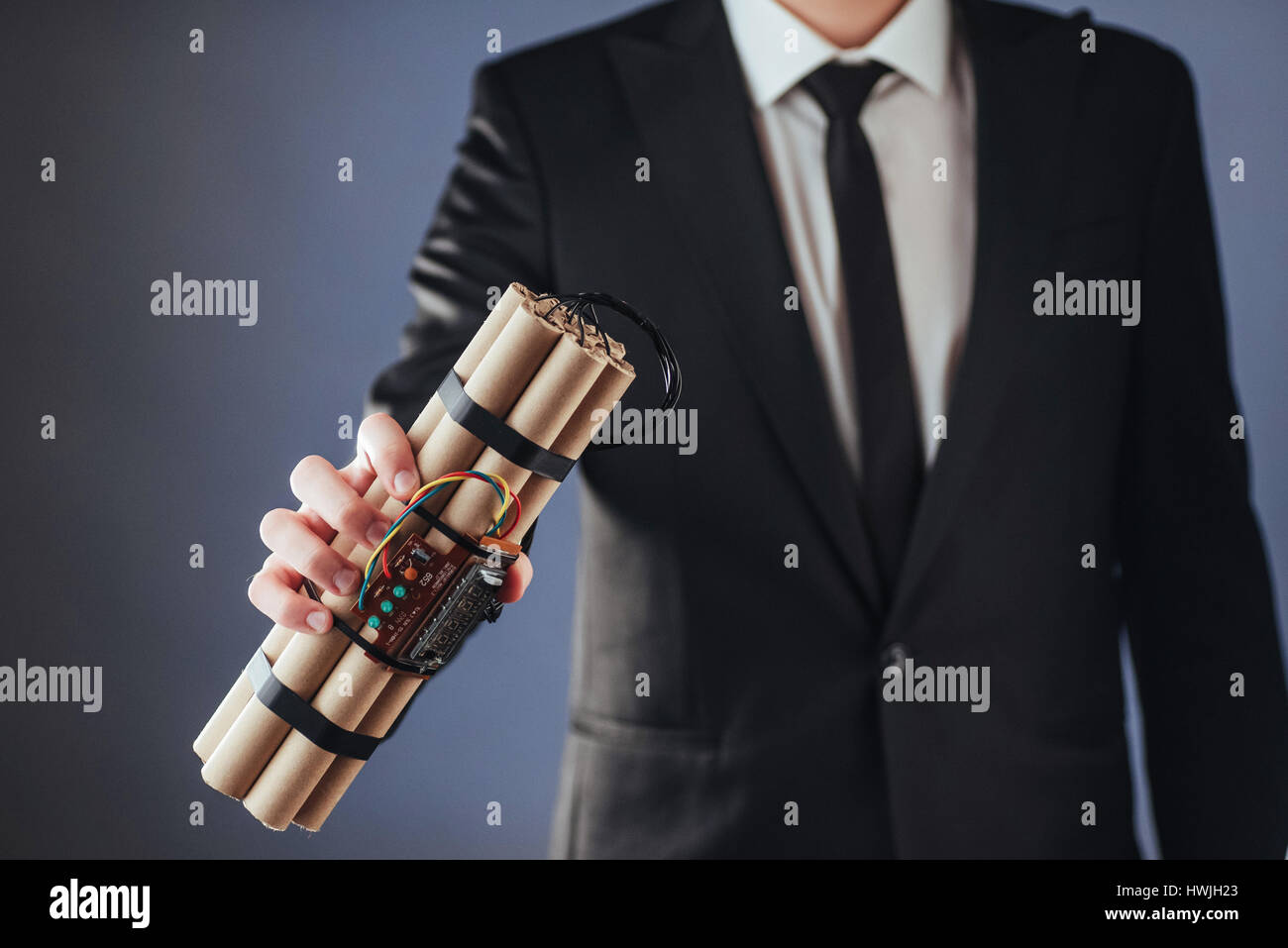 Man terrorist in a black suit with explosives and detonators Stock ...