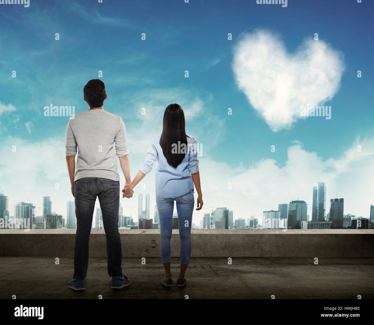 Back view of asian couple holding hand looking at the sky. Valentine's ...