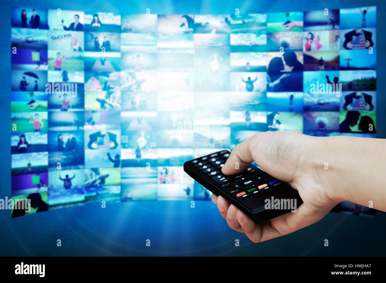 Big TV panel with television stream images and remote control in hand ...