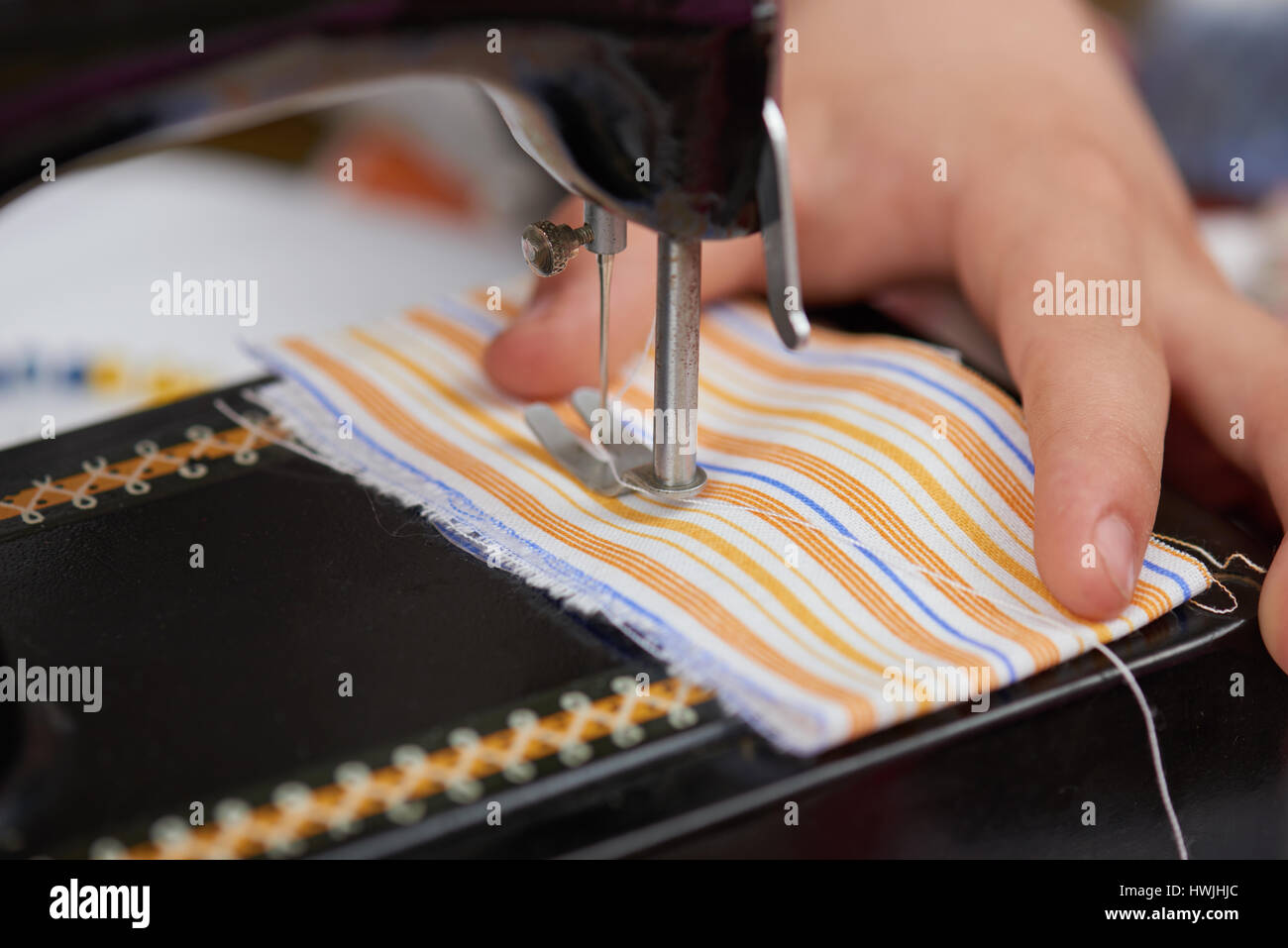 retro sewing machine and child hand closeup, handmade and handicraft ...