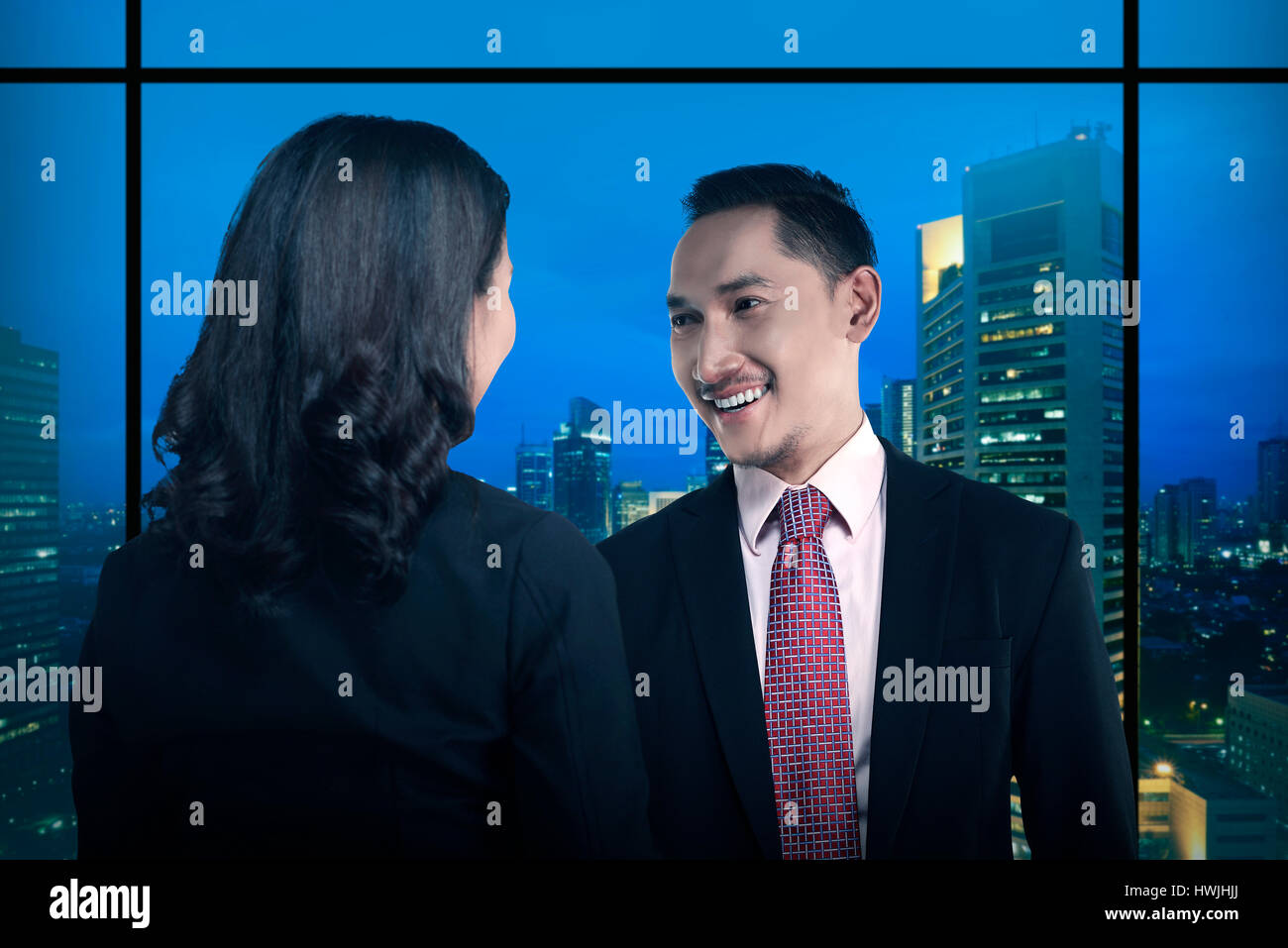 Business person talking with office window background Stock Photo - Alamy