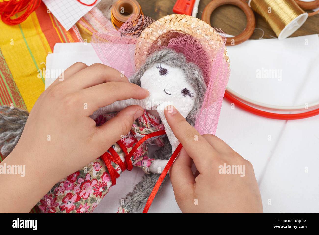 child hand making dress for handmade doll, learn to sewing Stock Photo ...