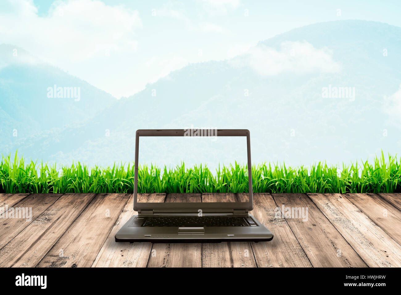 Laptop computer on the wooden floor with blue sky background Stock ...