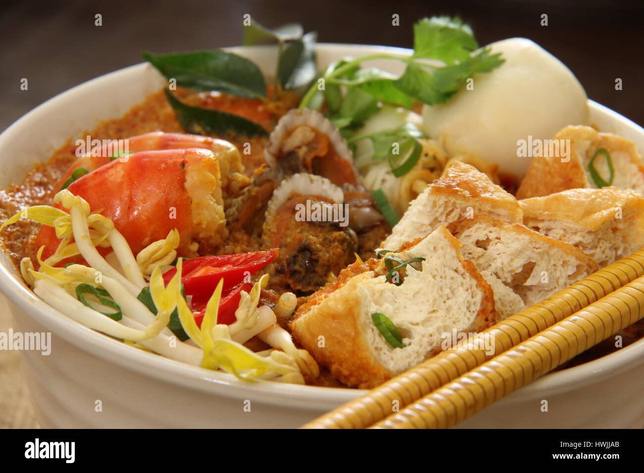 Curry Laksa. Peranakan curry noodle soup with seafood, bean curds, and ...