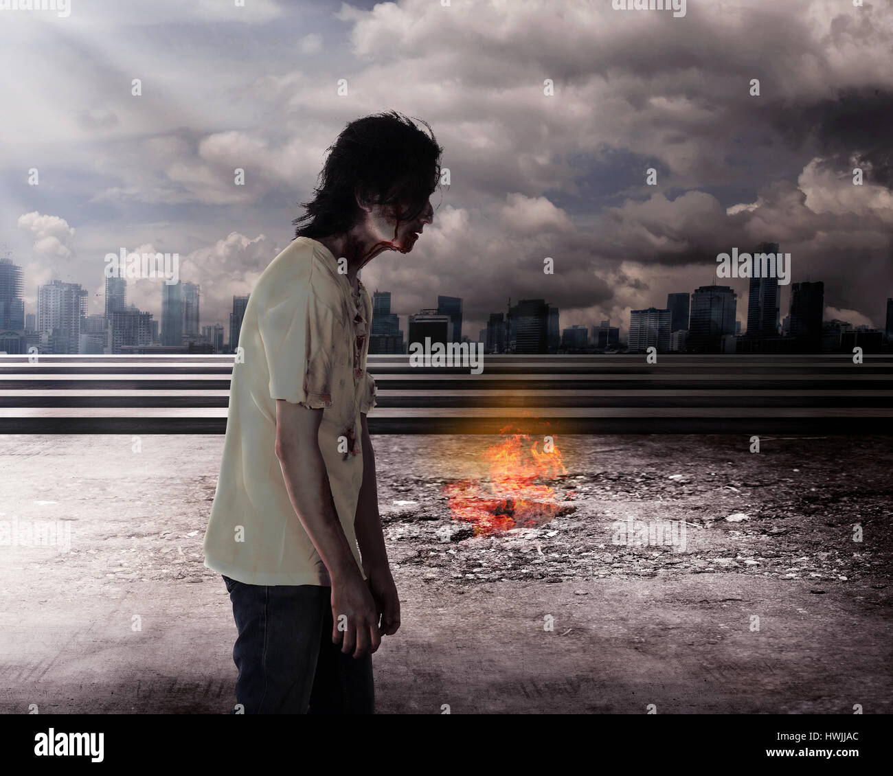 Creepy male zombie in the city that on fire Stock Photo - Alamy
