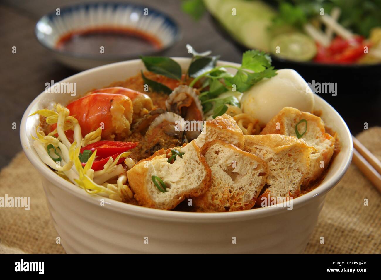 Curry Laksa. Peranakan curry noodle soup with seafood, bean curds, and ...