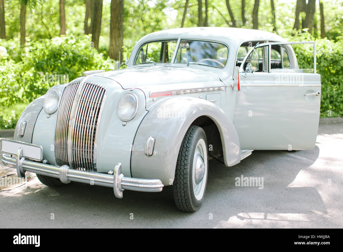 Gray retro car on green nature background Stock Photo - Alamy