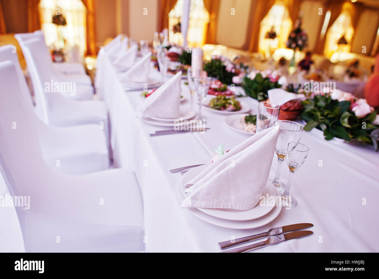 Table setting with plates and cutlery set at wedding table of newlyweds ...