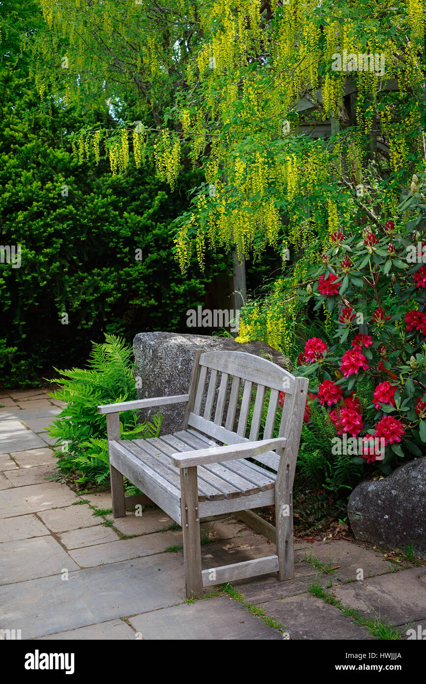 Park bench in a spring garden Stock Photo - Alamy
