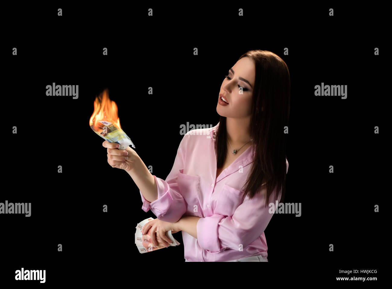 Pretty woman burns money. Concept of costs Stock Photo - Alamy