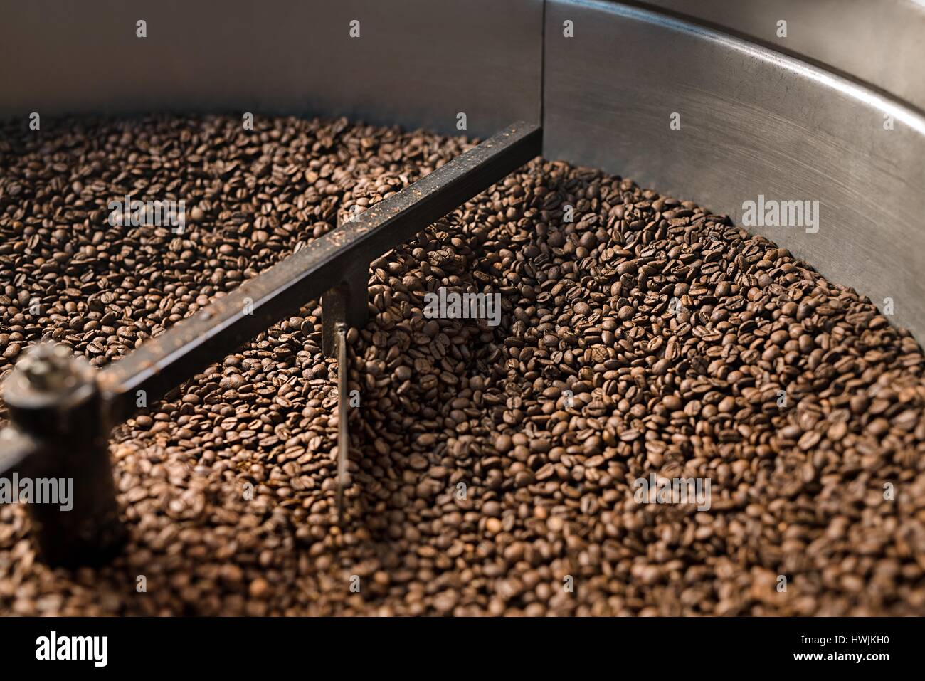 Coffee beans sifted and stirred in roasting machine Stock Photo - Alamy