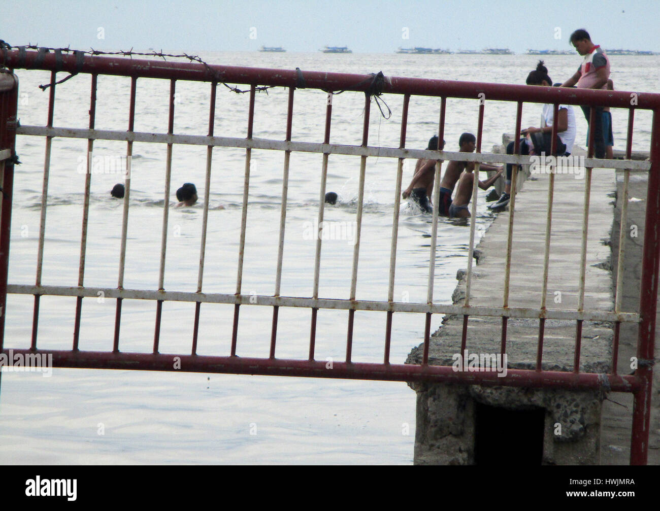 Manila, Philippines. 21st Mar, 2017. Filipino boys swim along the coast ...