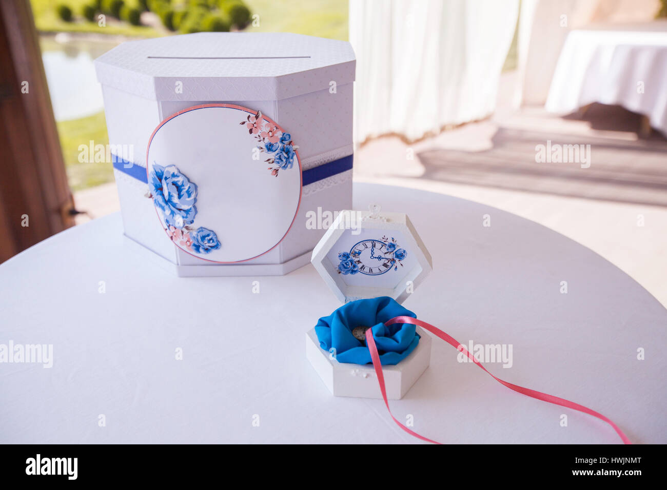 Wedding mail box and tender white casket on round table Stock Photo - Alamy