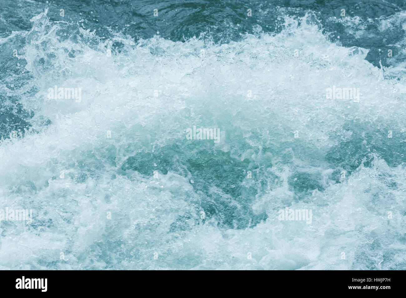 splashes of mountain river waves close up. Churning blue water in the ...