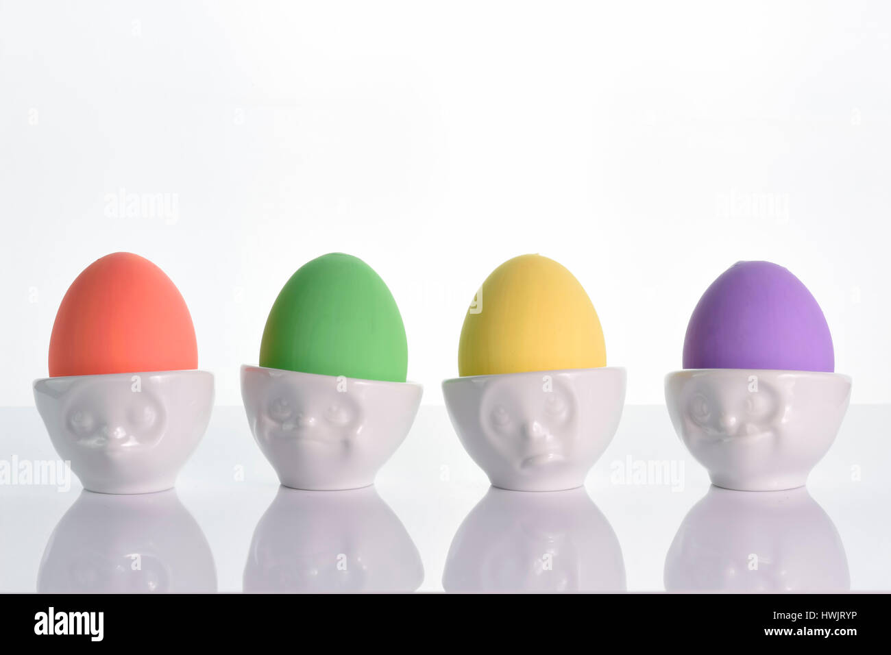 Vibrant colorful easter eggs in cute cups Stock Photo - Alamy