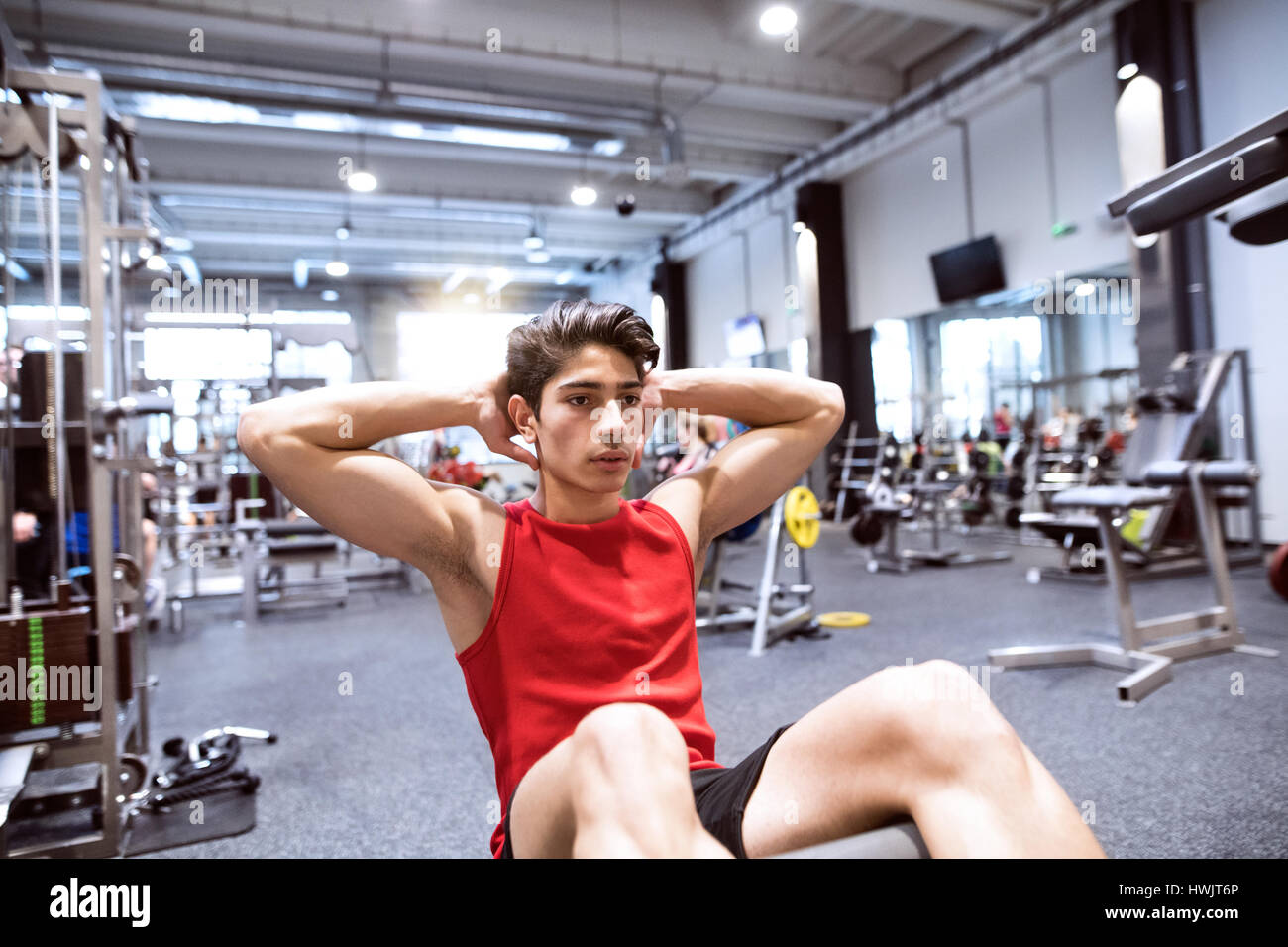 Fit hispanic man doing crunches, exercising abdominal muscles during ...
