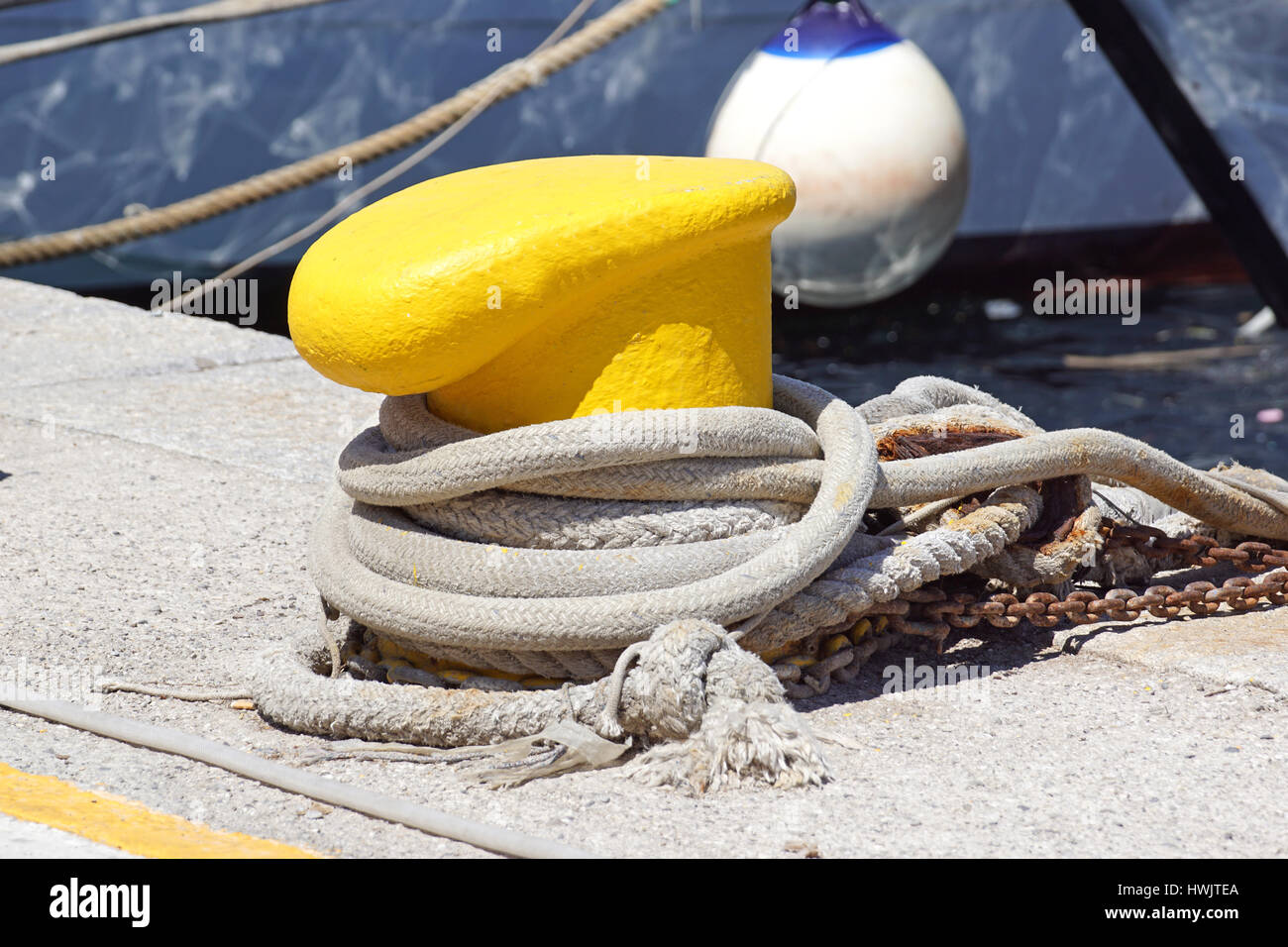 mooring dock with nautical ropes chains Stock Photo - Alamy