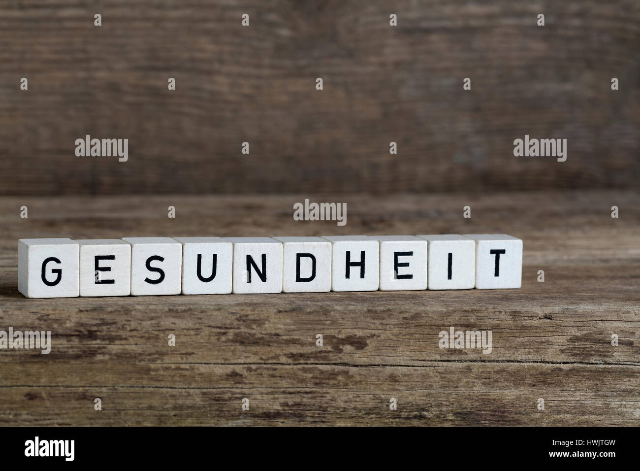 German word health, written in cubes on a wooden background Stock Photo ...