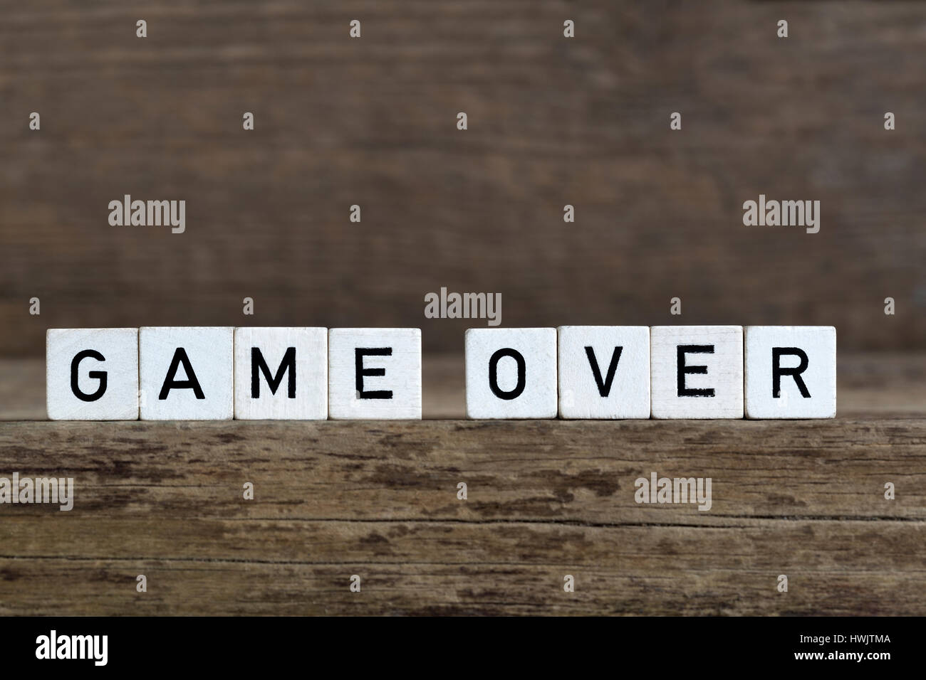 Game over, written in cubes on a wooden background Stock Photo - Alamy
