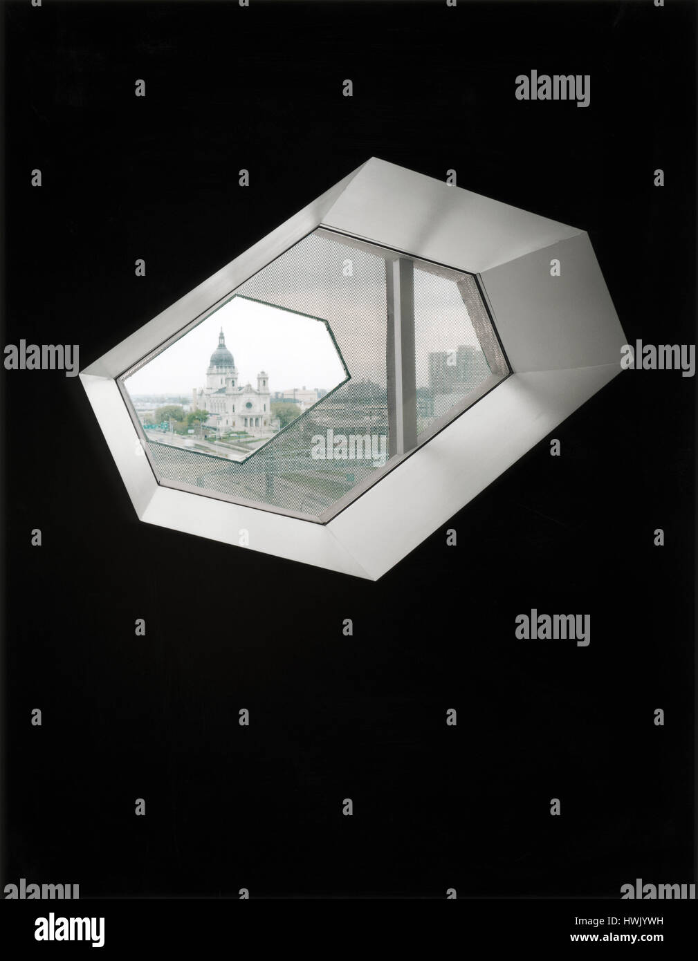 Window in the stairwell framing the view of a historic church. Walker ...
