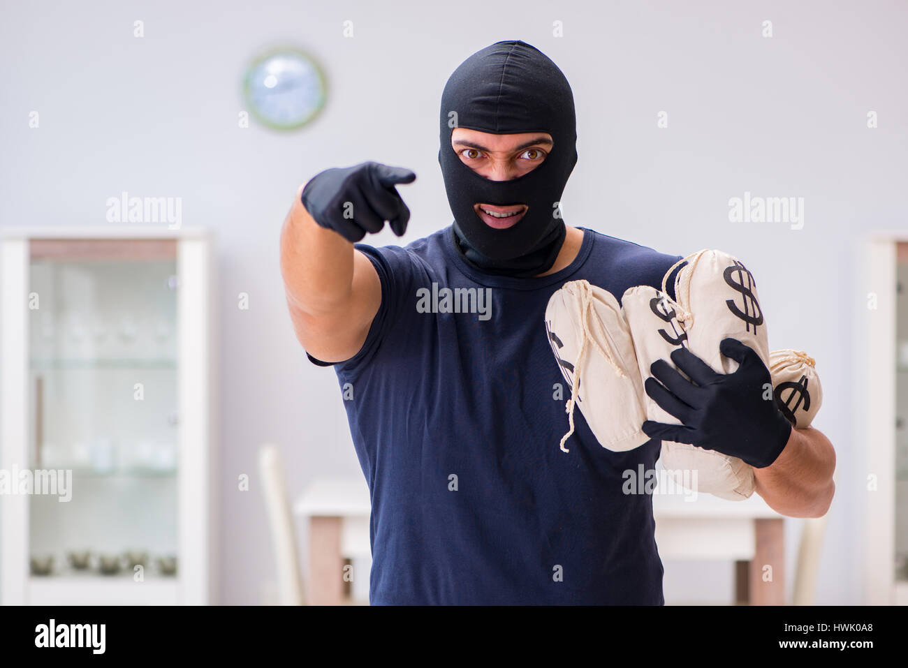 Robber wearing balaclava stealing valuable things Stock Photo - Alamy
