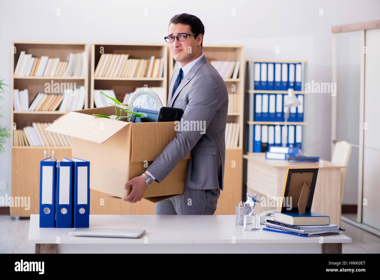 Man moving office with box and his belongings Stock Photo - Alamy