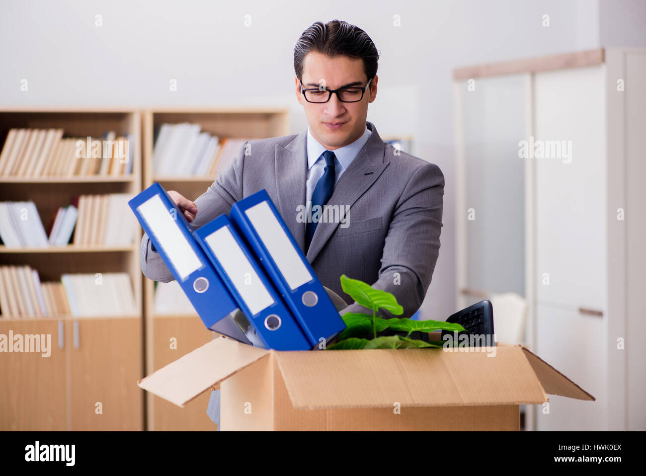 Man moving office with box and his belongings Stock Photo - Alamy