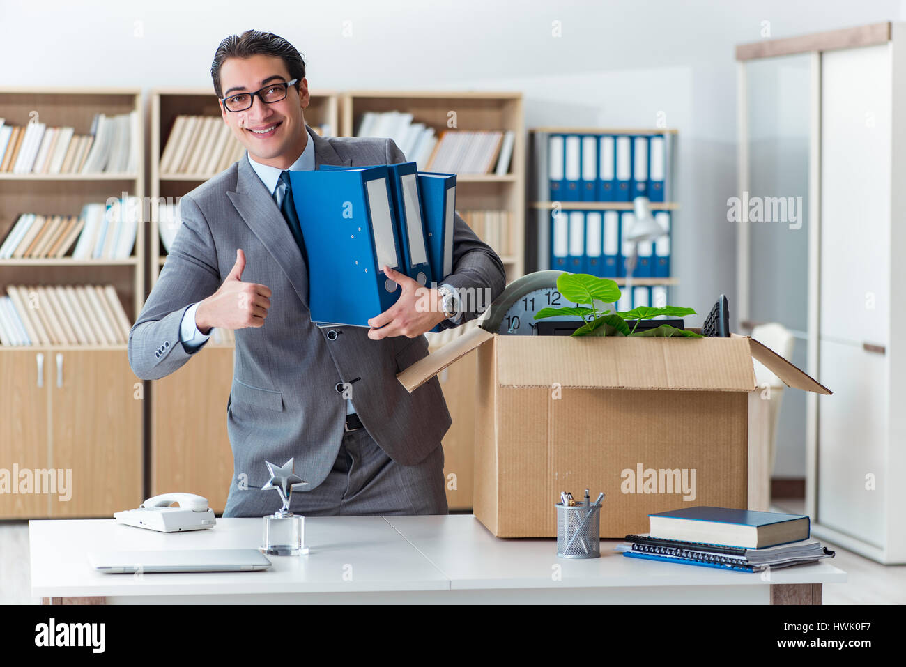Man moving office with box and his belongings Stock Photo - Alamy