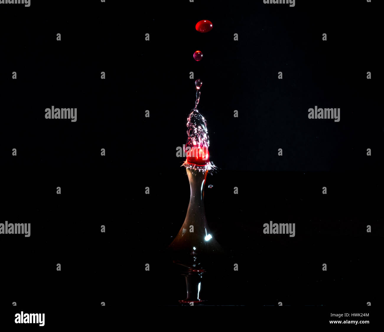 Images forming two drops of water when colliding after falling in water ...
