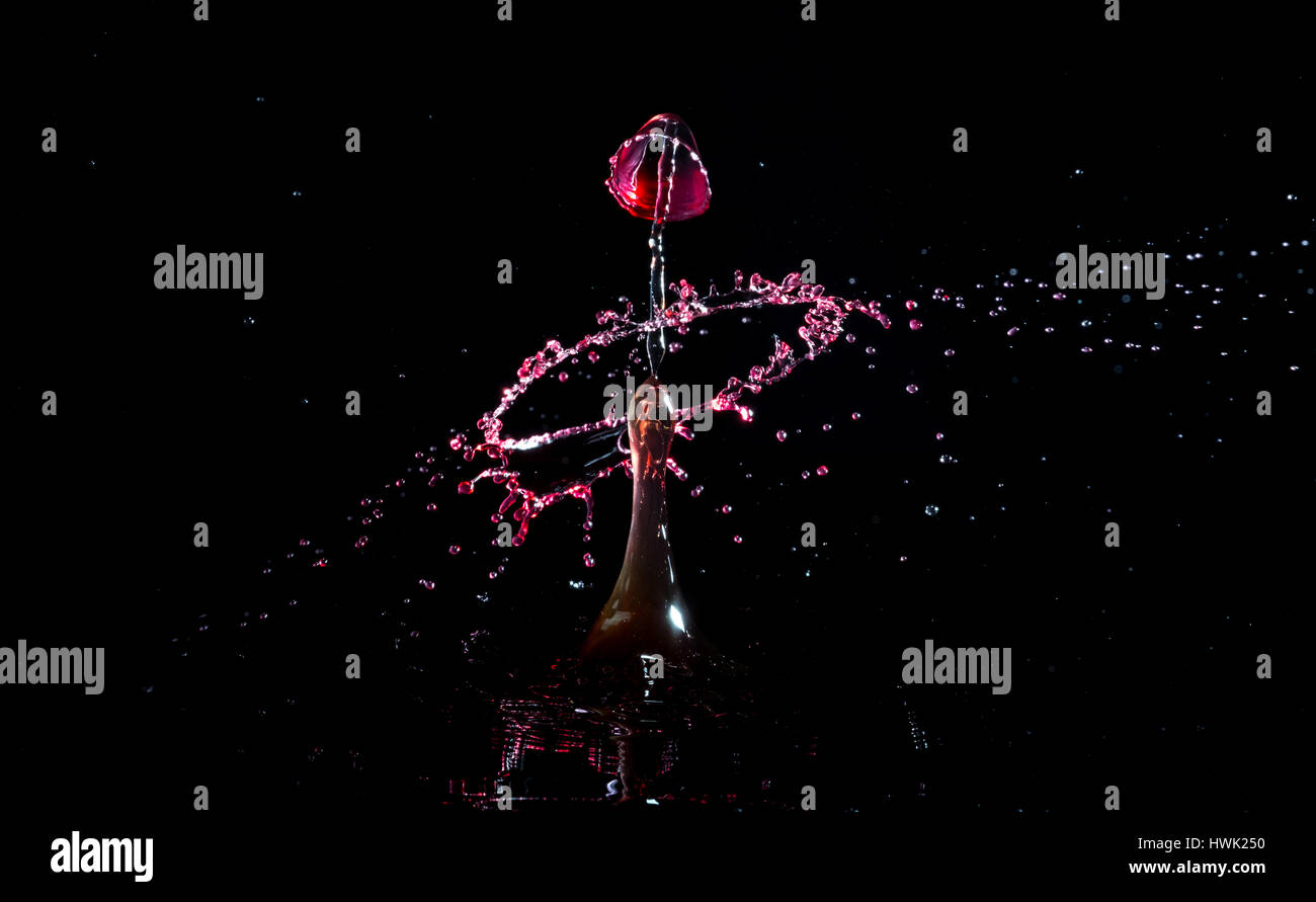 Images forming two drops of water when colliding after falling in water ...
