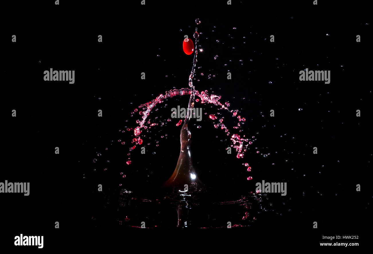 Images forming two drops of water when colliding after falling in water ...