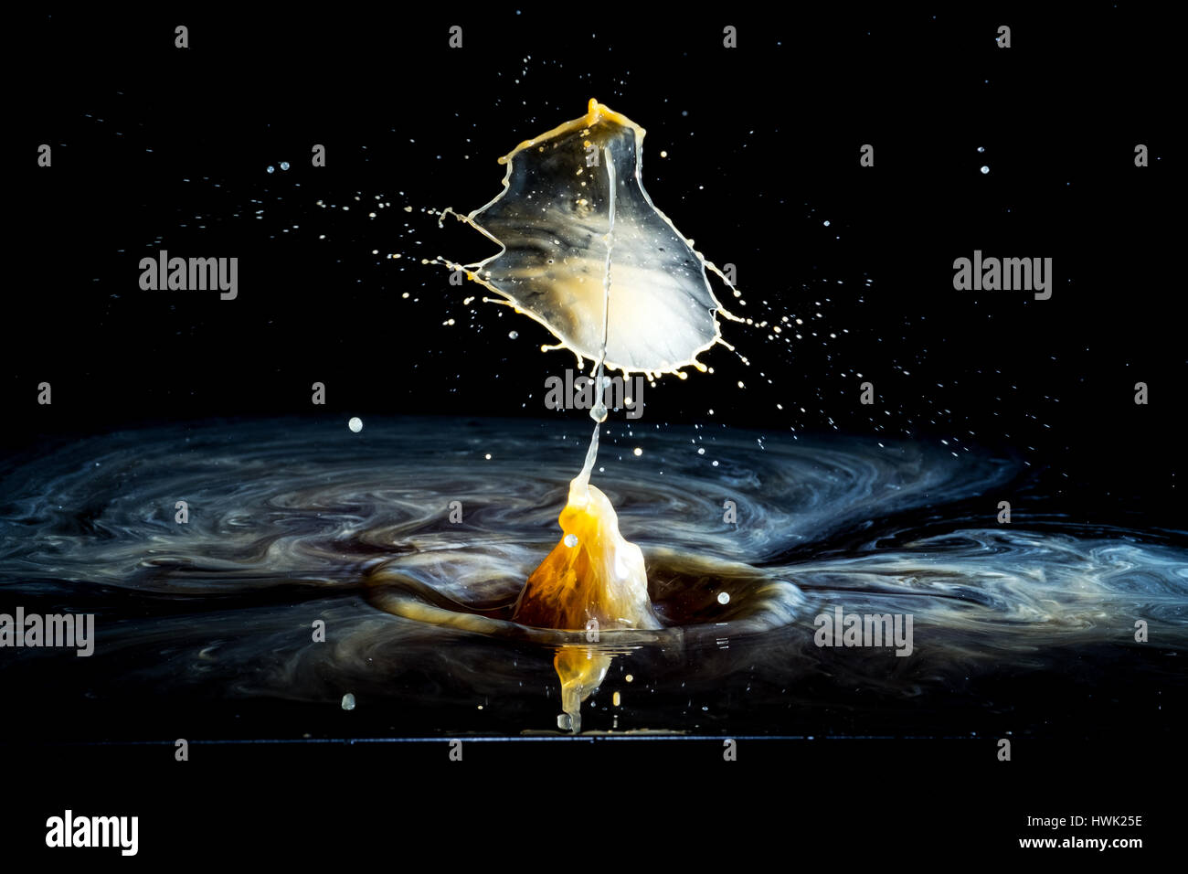 Images forming two drops of water when colliding after falling in water ...
