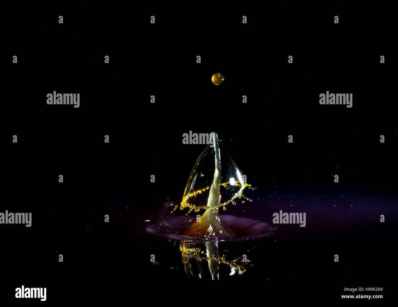 Images forming two drops of water when colliding after falling in water ...
