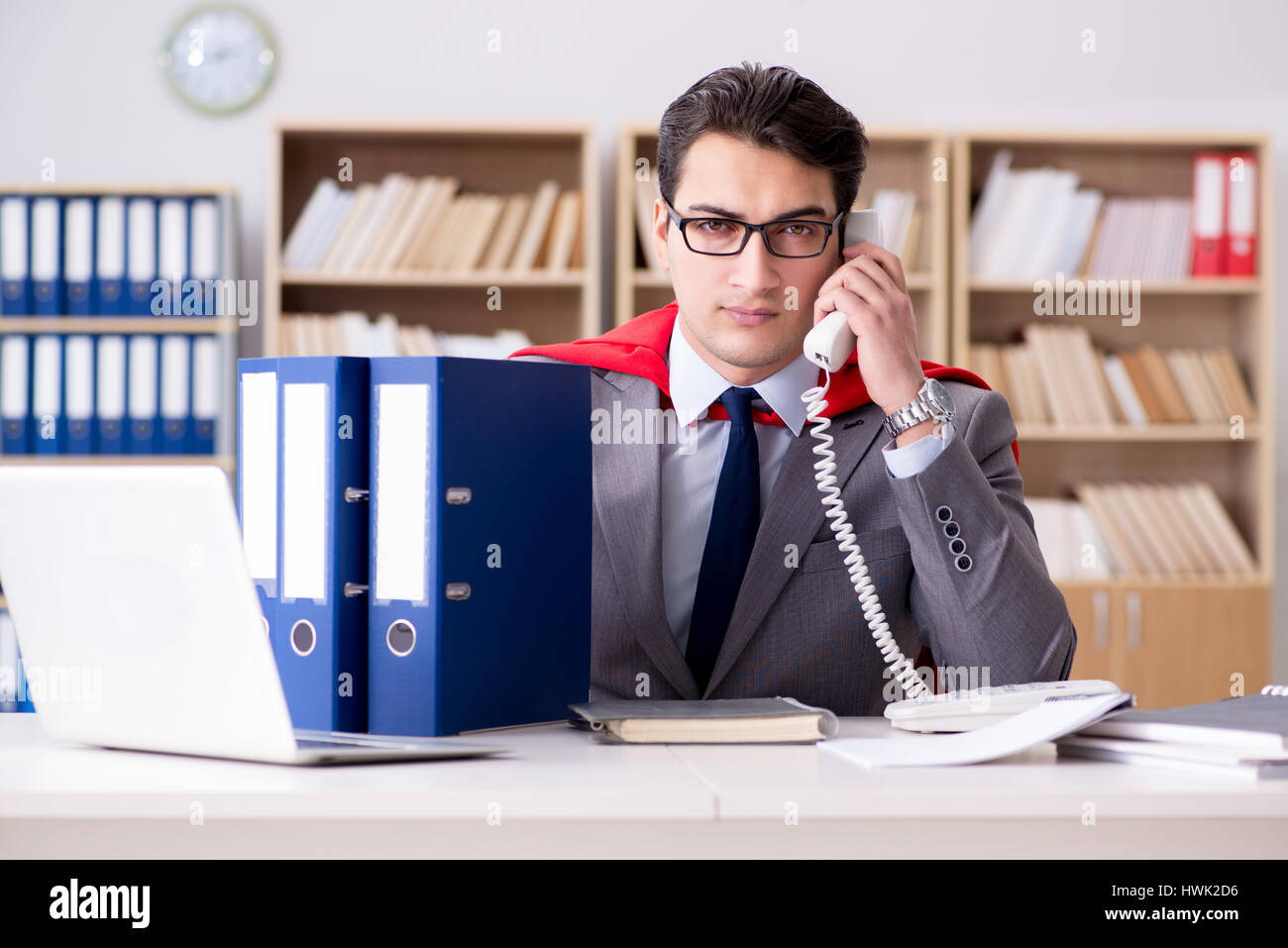 Superhero businessman working in the office Stock Photo - Alamy