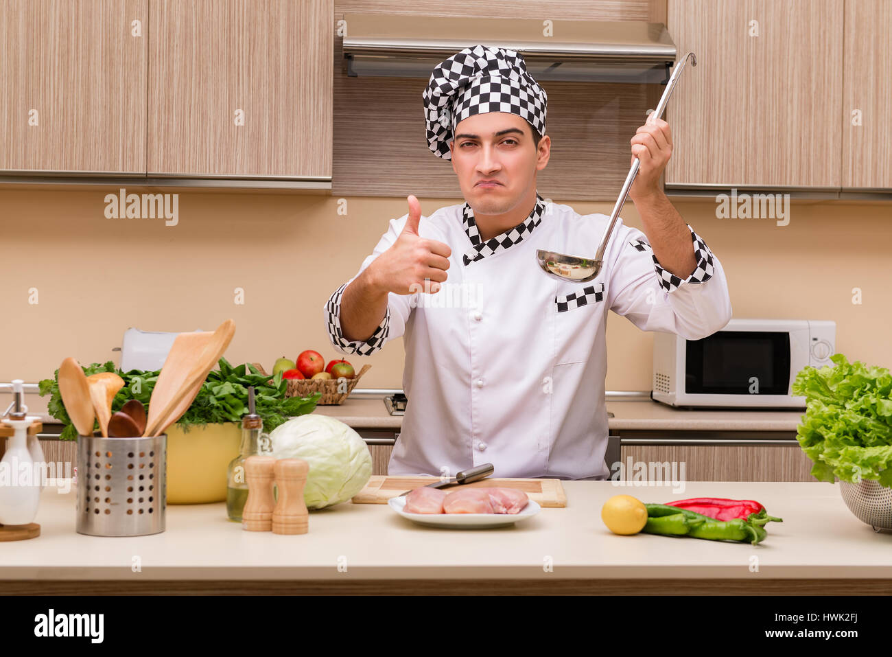 Young chef working in the kitchen Stock Photo - Alamy