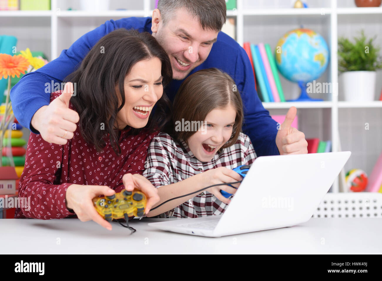 Portrait of a family playing a computer game Stock Photo - Alamy